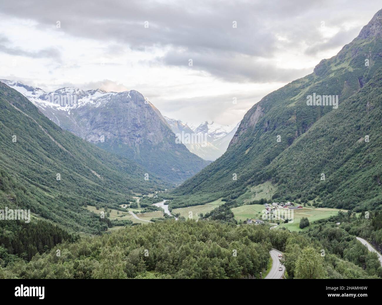 Norwegian landscape with green valley between mountains with snow peaks ...