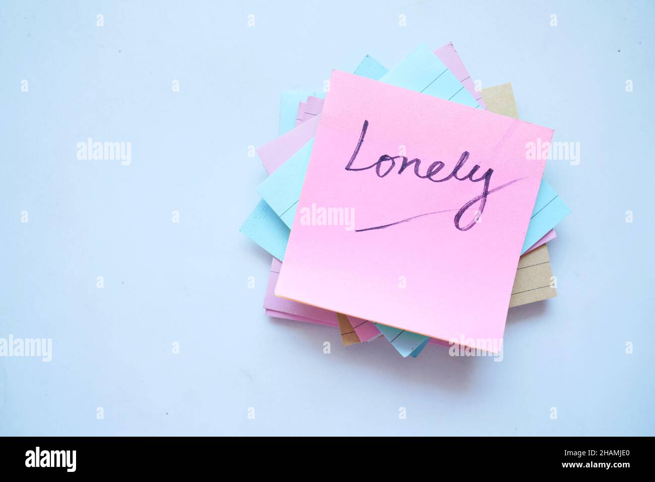 hand written lonely text on a sticky note on white background Stock ...