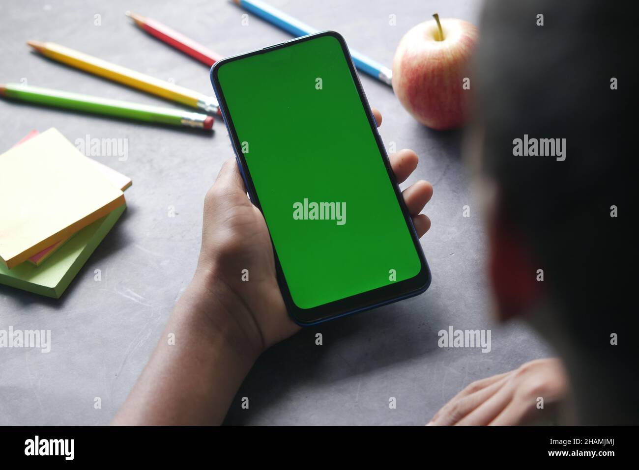 rear view of child hand pointing finger on smart phone screen Stock ...