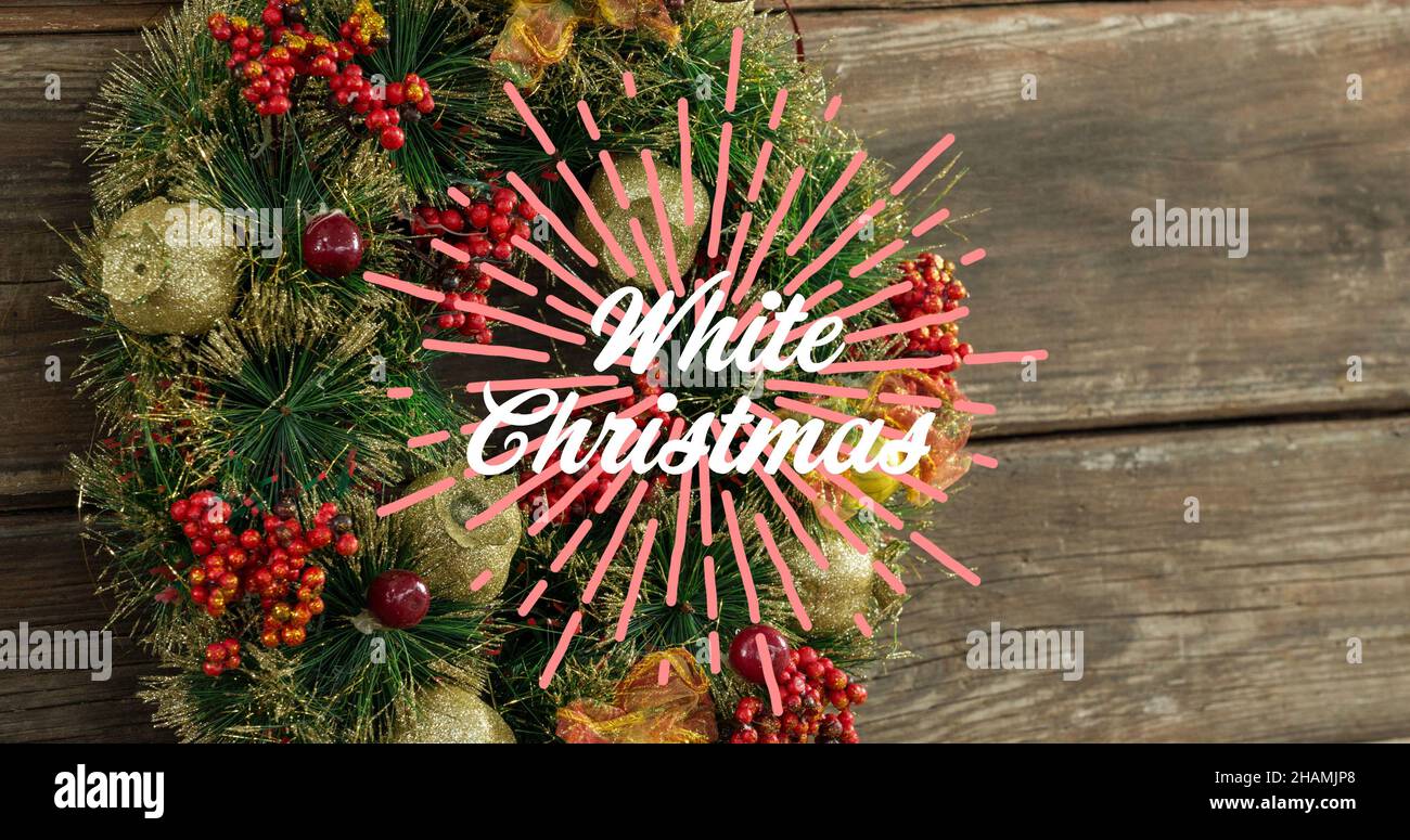 Overhead view of white christmas with rays over decorations on wooden ...