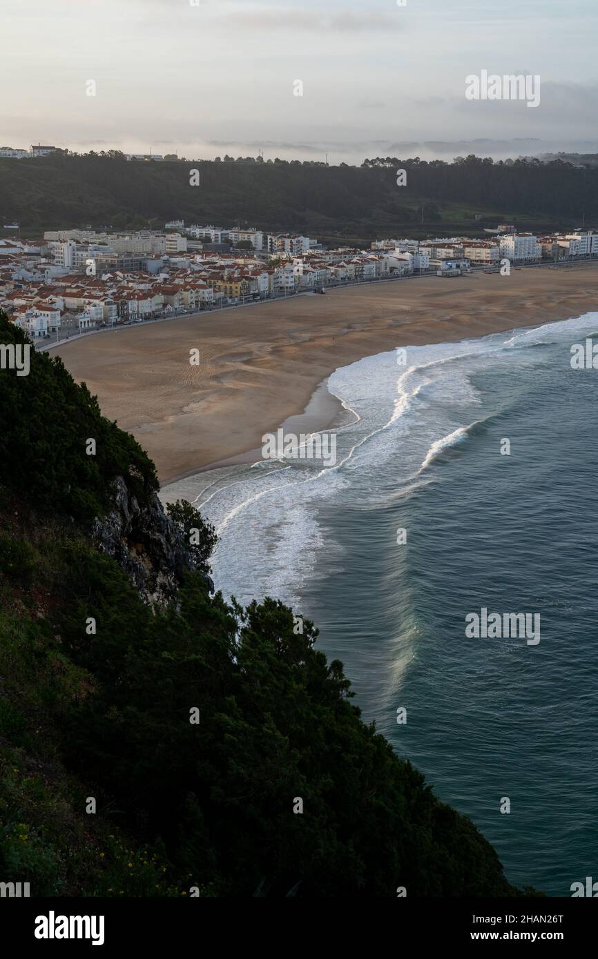Vertical shot of Nazare town during the sunrise Stock Photo - Alamy