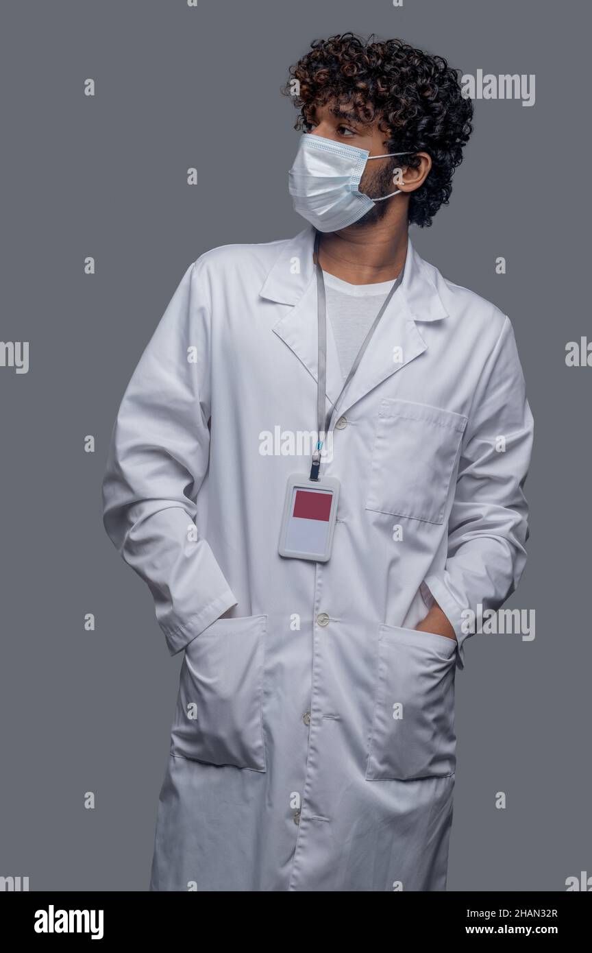 Healthcare professional dressed in a lab coat staring away Stock Photo ...