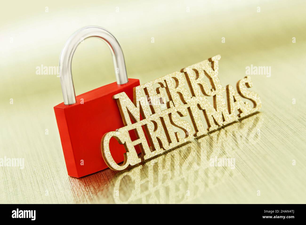 Merry Christmas and red symbolic lock on golden background Stock Photo ...