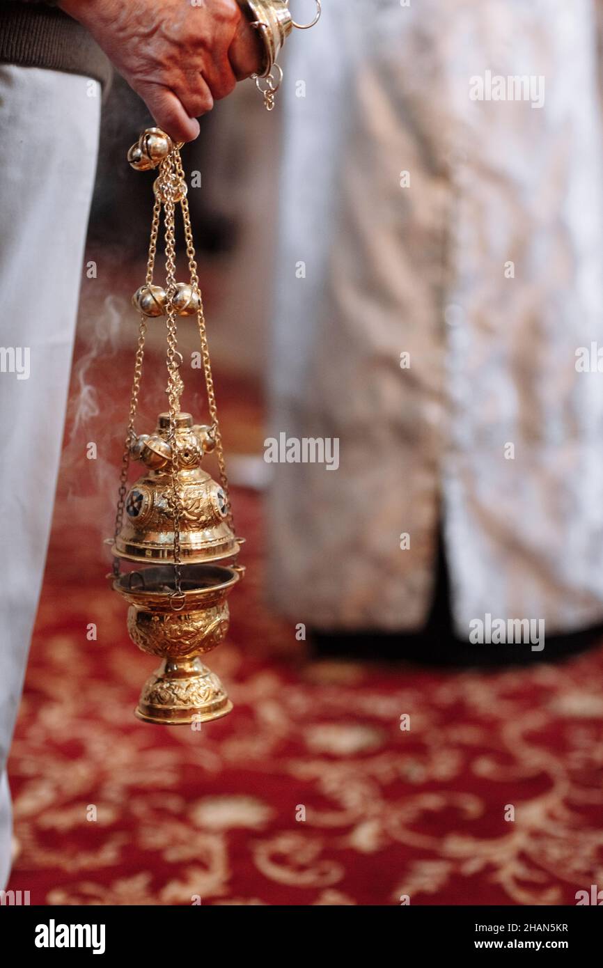 A priest in the Orthodox Christian Church holds in his hands the censer ...