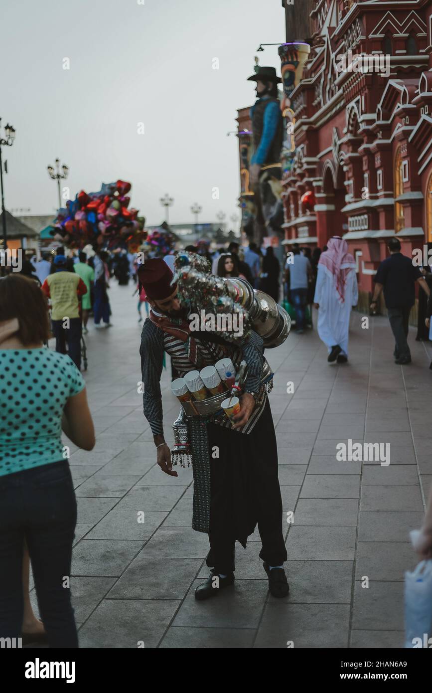 Turkish tea seller man holding giant tea pot and serving tea outdoor on ...