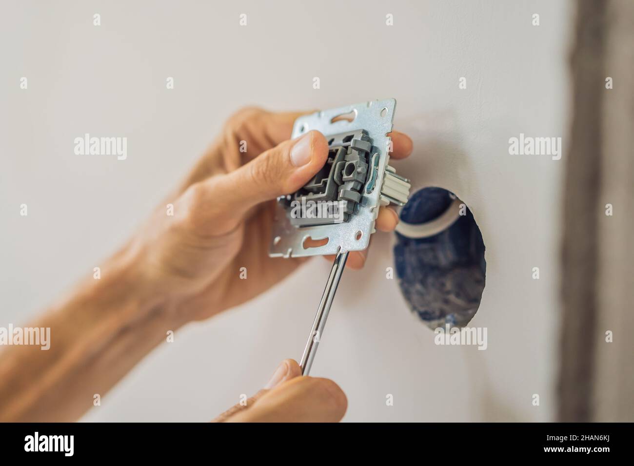 Master electrician installs a socket in the house Stock Photo - Alamy
