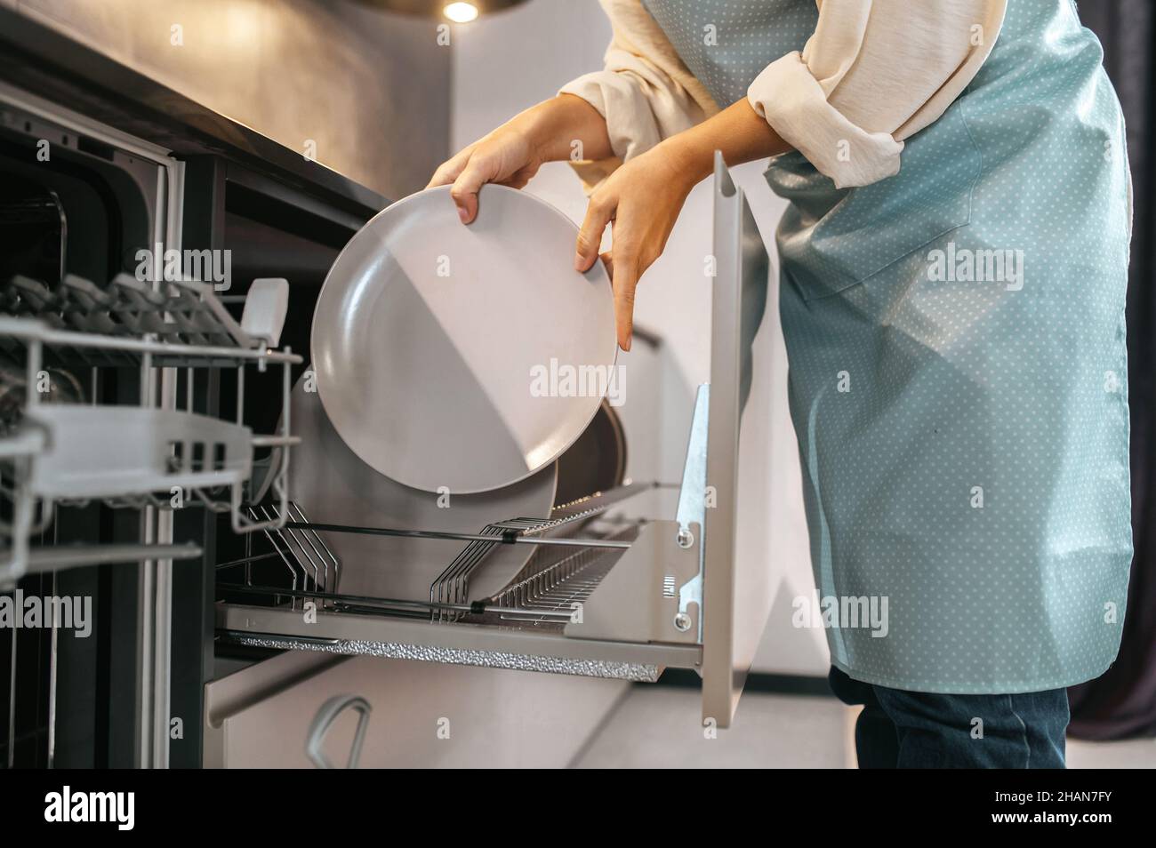Housewife taking out clean plates hi-res stock photography and images ...