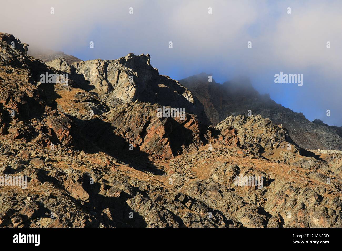 Red colored rocks in Zermatt Stock Photo - Alamy