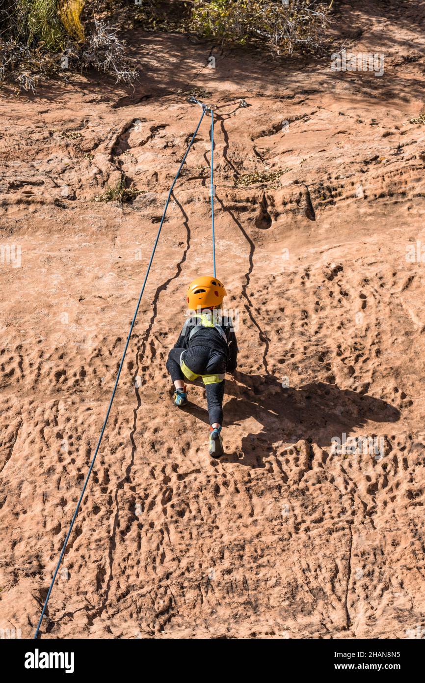 A five-year old girl learning to rock climb at the Wall Street climbing ...
