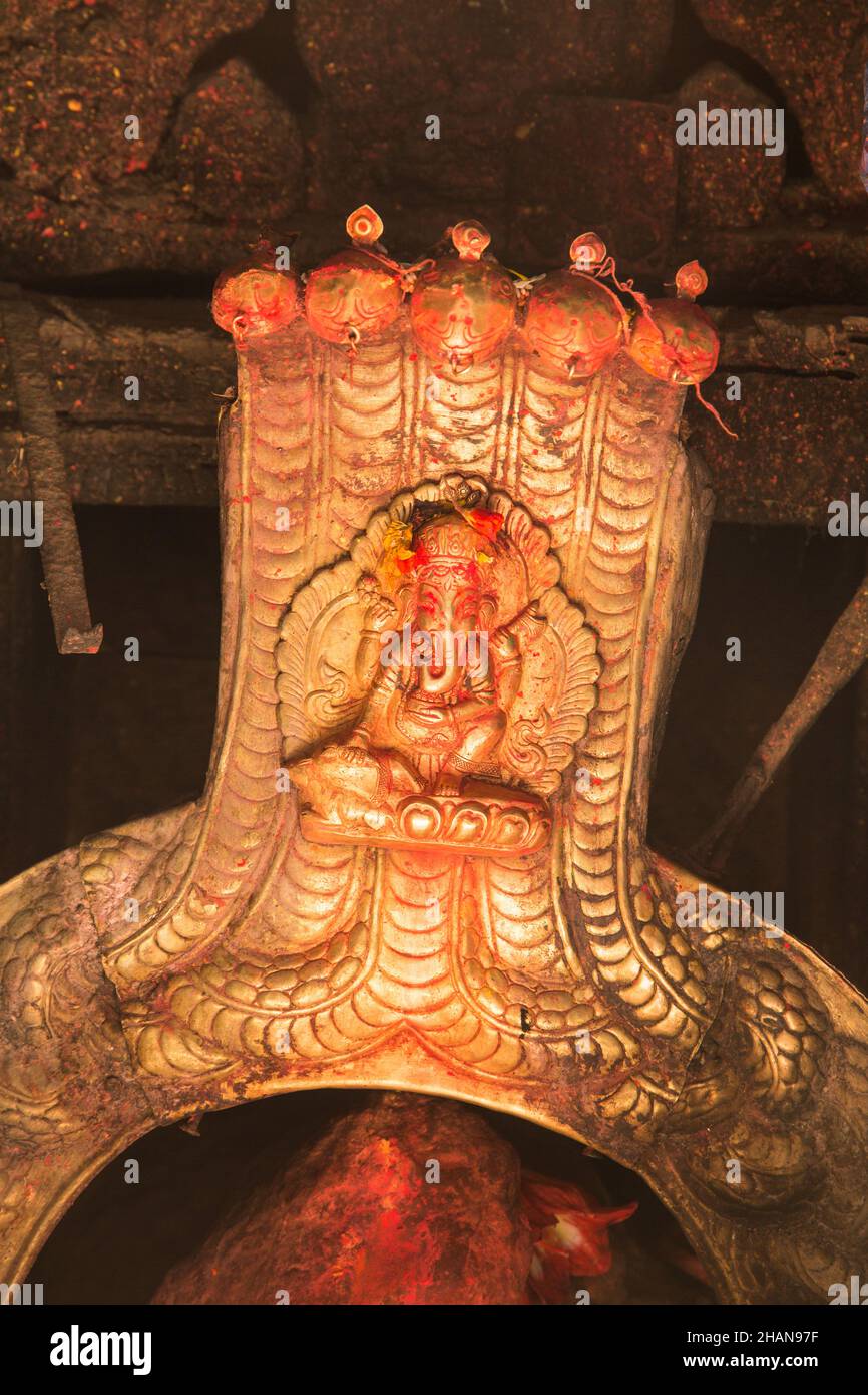 Detail of the copper sculpture of Ganesh with five Naga serpents behind ...