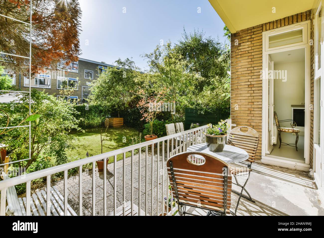 Cozy sunny veranda of the house with wooden chairs Stock Photo - Alamy