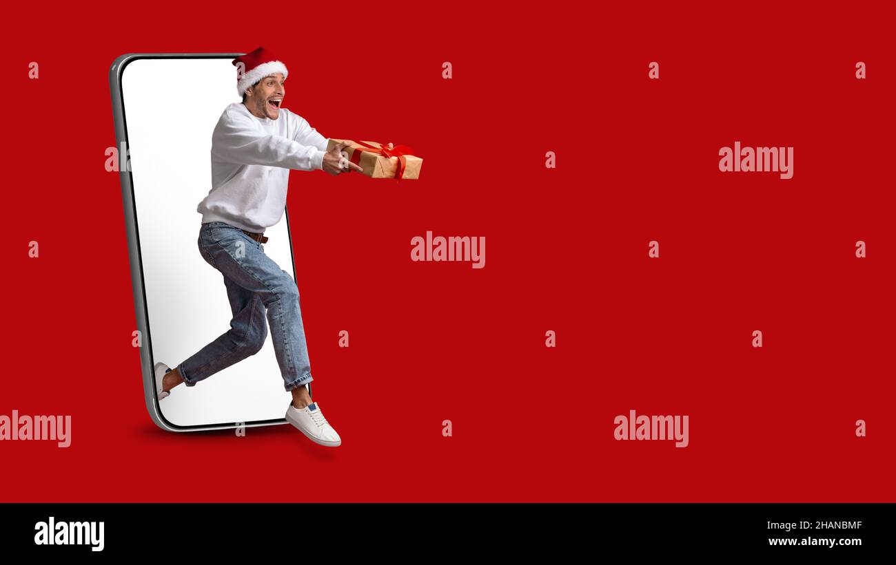 Christmas Delivery. Excited Guy With Gift Box Jumping Out Of Big ...