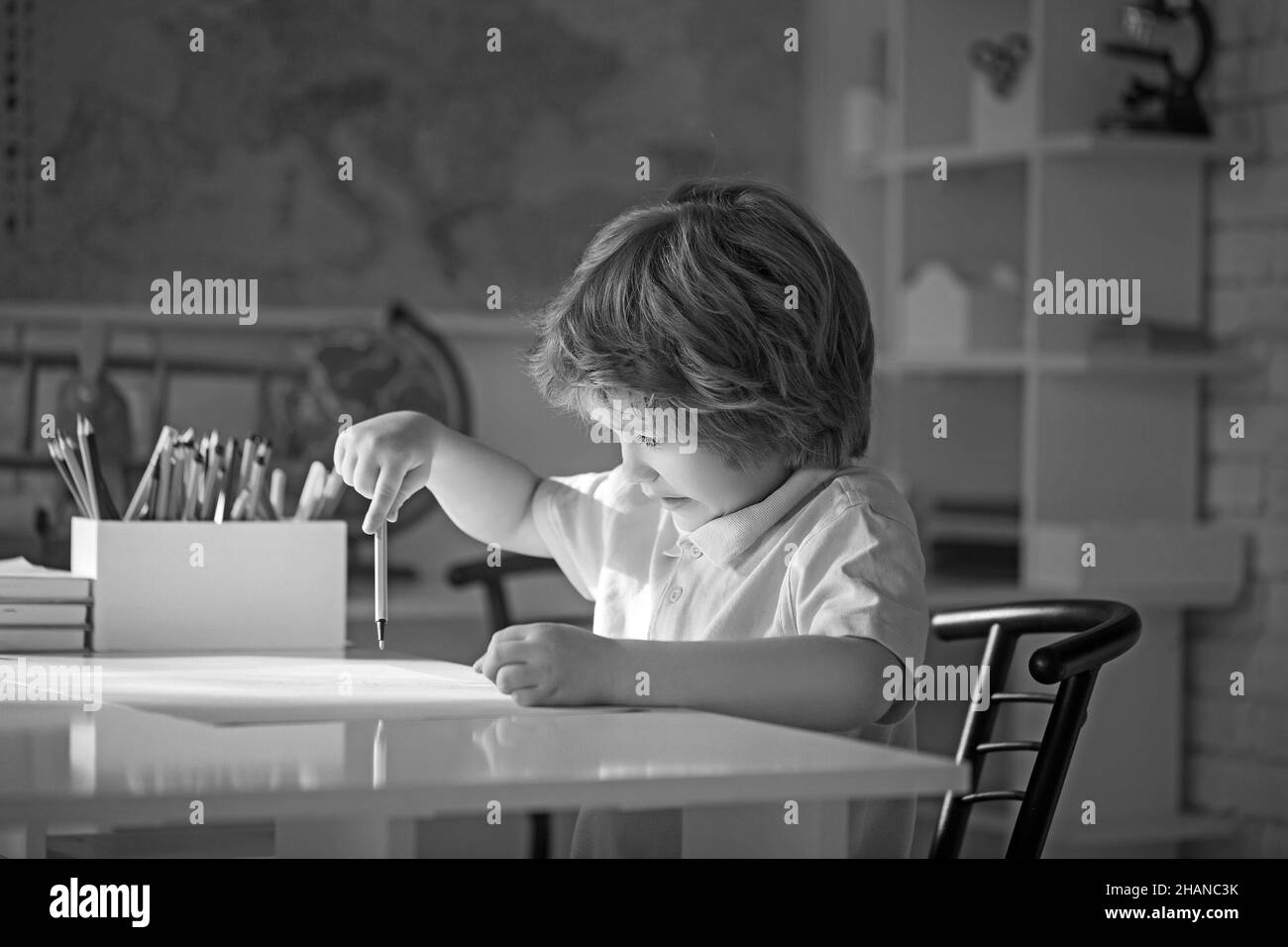 Young boy painting decorative lettering with pen color paint Stock ...
