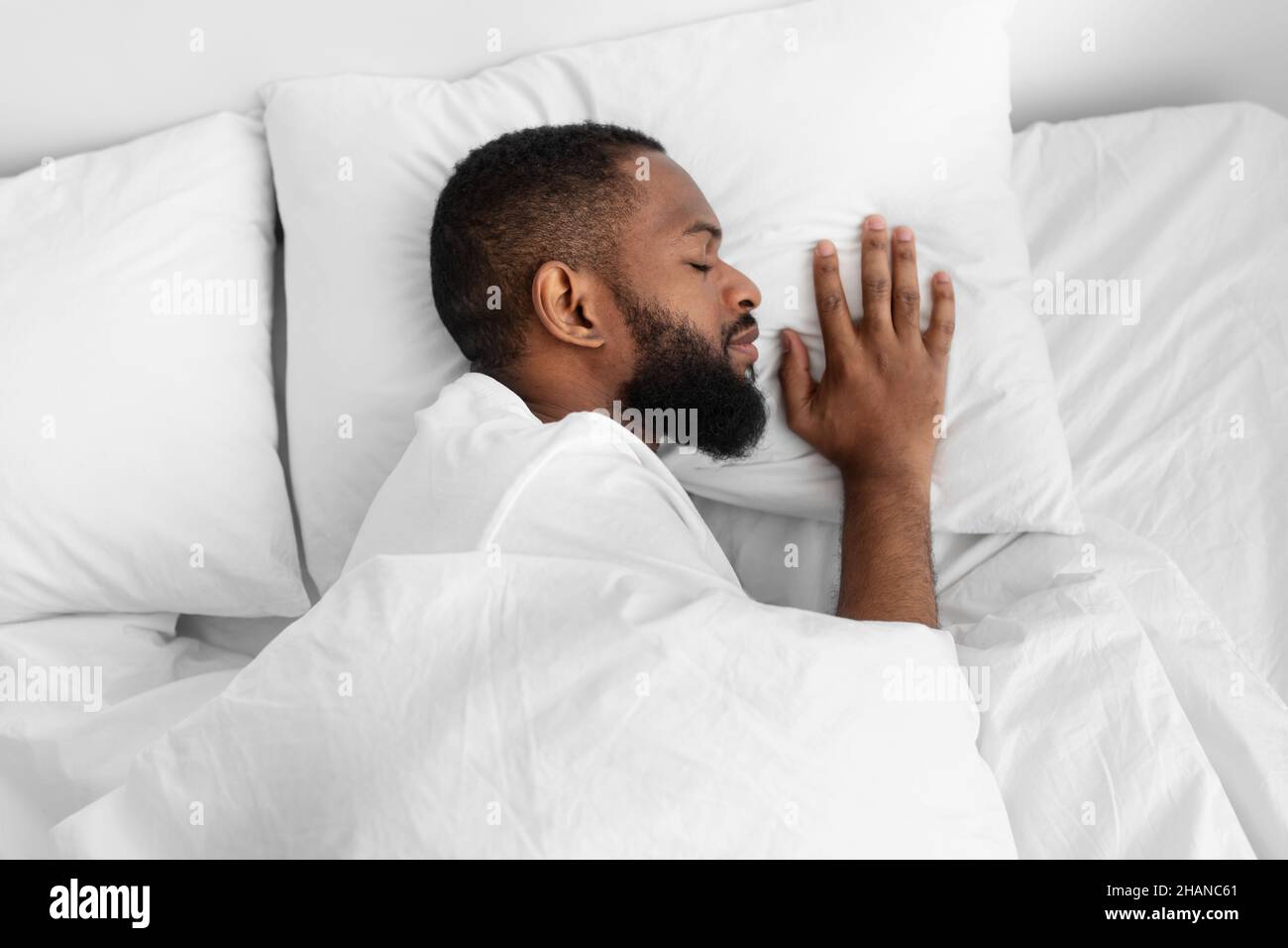 African man sleeping on bed hi-res stock photography and images - Alamy