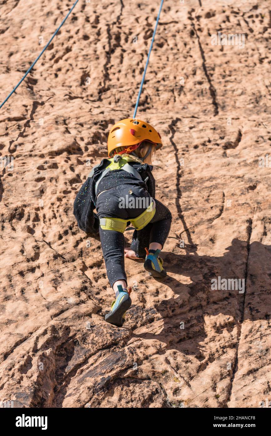 A five-year old girl learning to rock climb at the Wall Street climbing ...