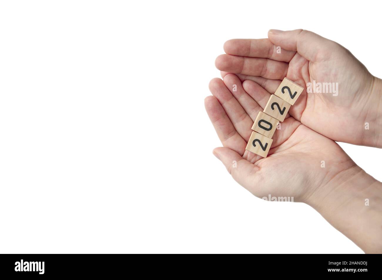 Person's hand holding 2022 on white background top view a minimal ...