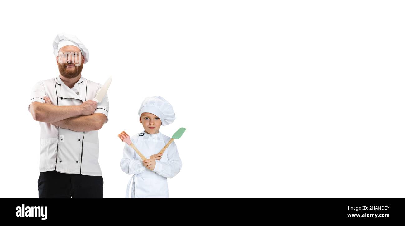 Young bearded man, cook, male chef in white uniform and his little ...