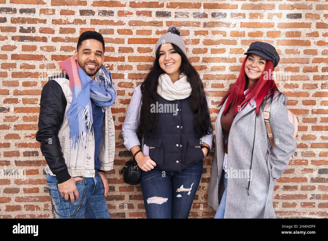 Positive multiracial young male and female friends wearing trendy ...