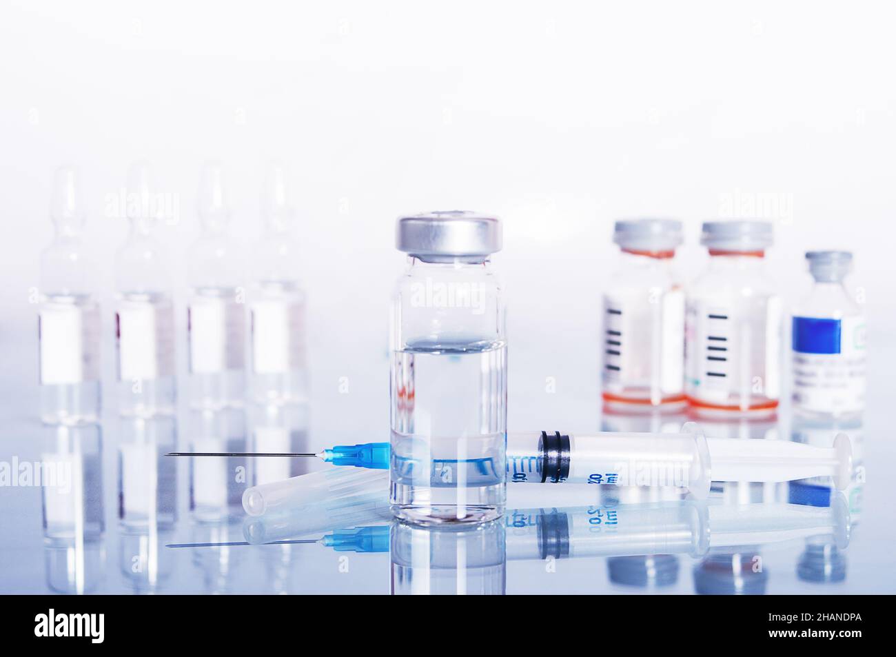 syringe and diferent kind of ampoules and vials close-up on white ...