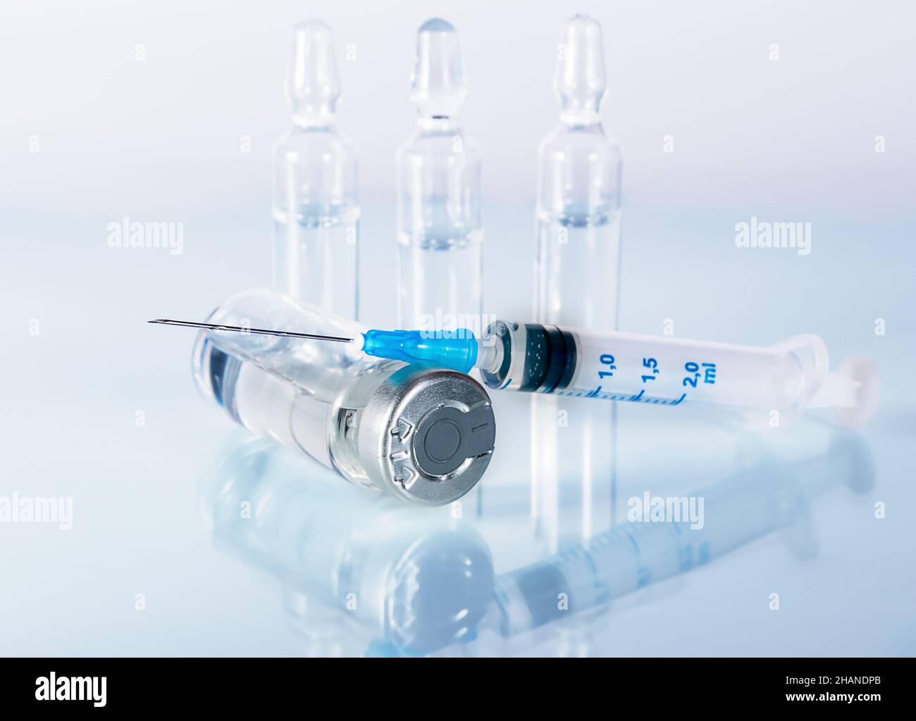 syringe and diferent kind of ampoules and vials close-up on white ...