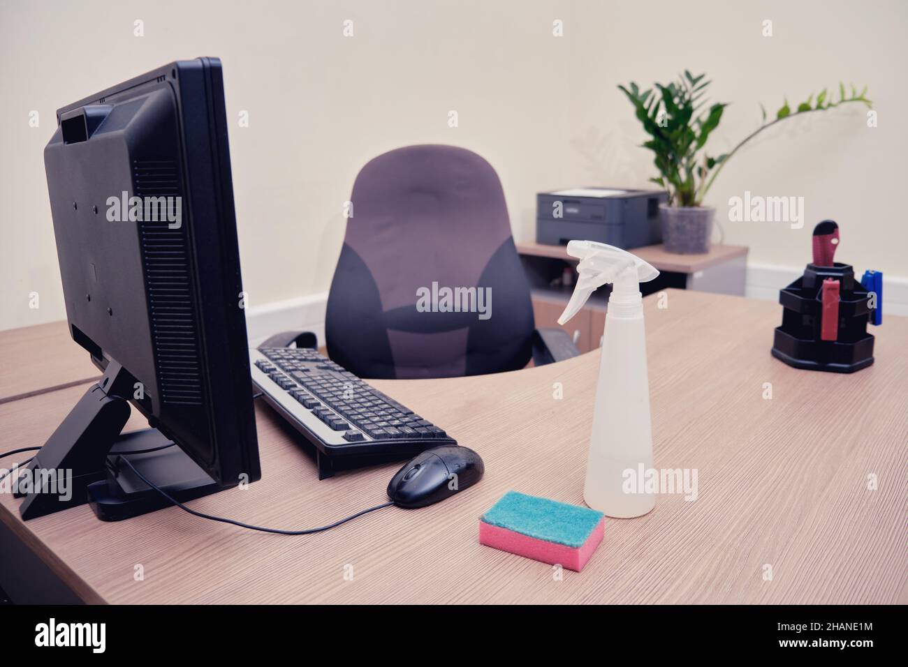 Cleaning the office, wipes tables and computer equipment with a sponge ...