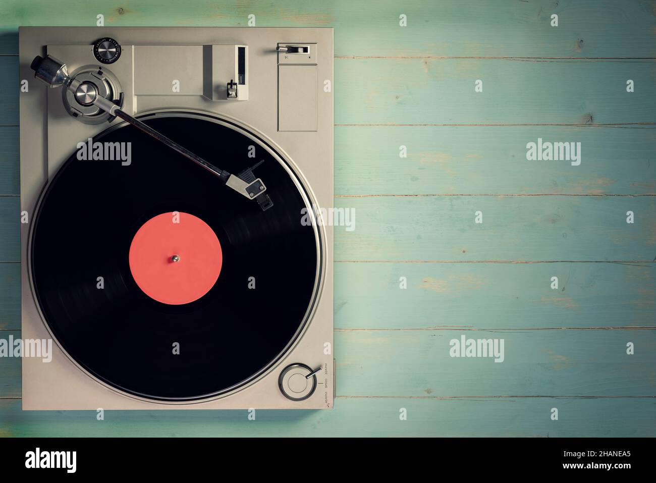 Gramophone with a vinyl record on wooden table, top view and copy space ...