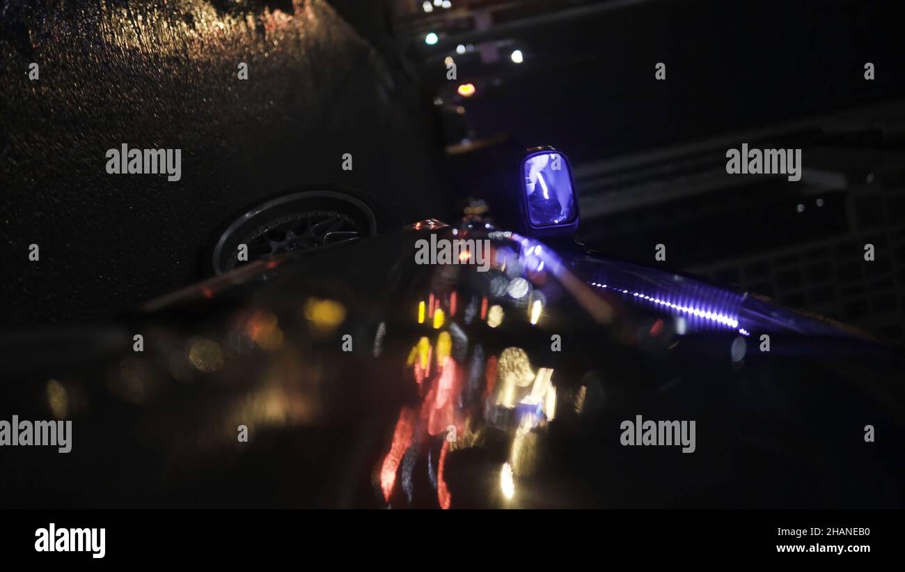 Night city from the car back view. Footage. Car rear view mirror in the ...