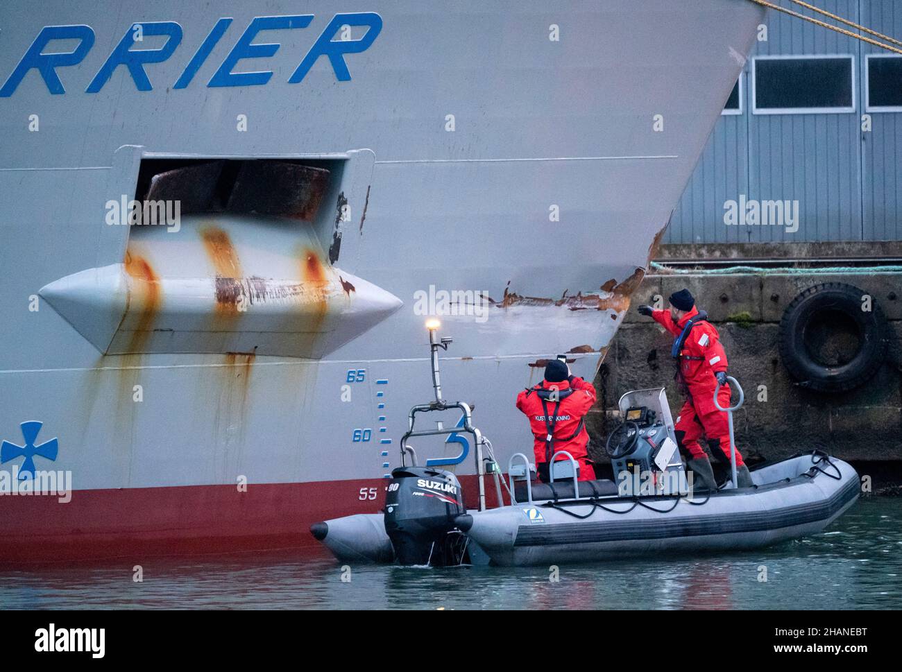 Personnel from the Swedish Coast Guard investigate the damaged ship ...