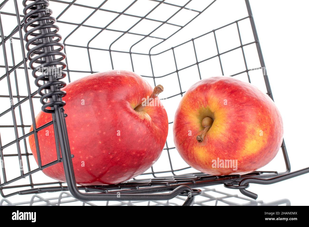 Two organic red apples with a basket, close-up, isolated on white Stock ...