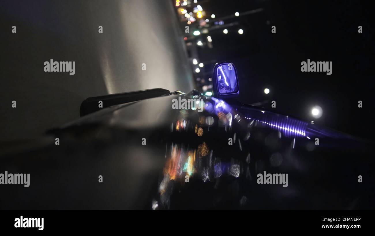 Night city from the car back view. Footage. Car rear view mirror in the ...