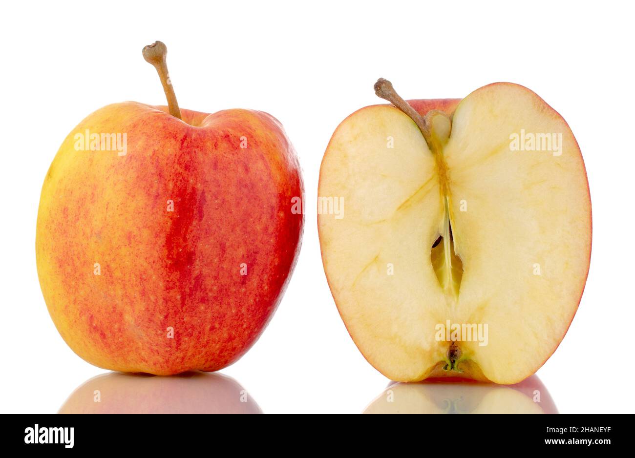 One half and one whole organic red apples, close-up, isolated on white ...