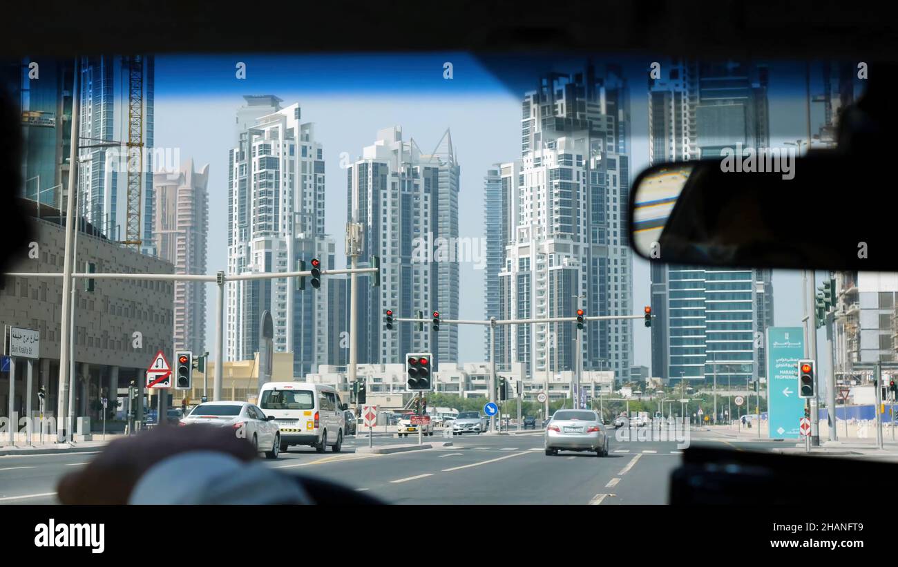 Businessman traveling by car in Dubai with a view of the car. View from ...