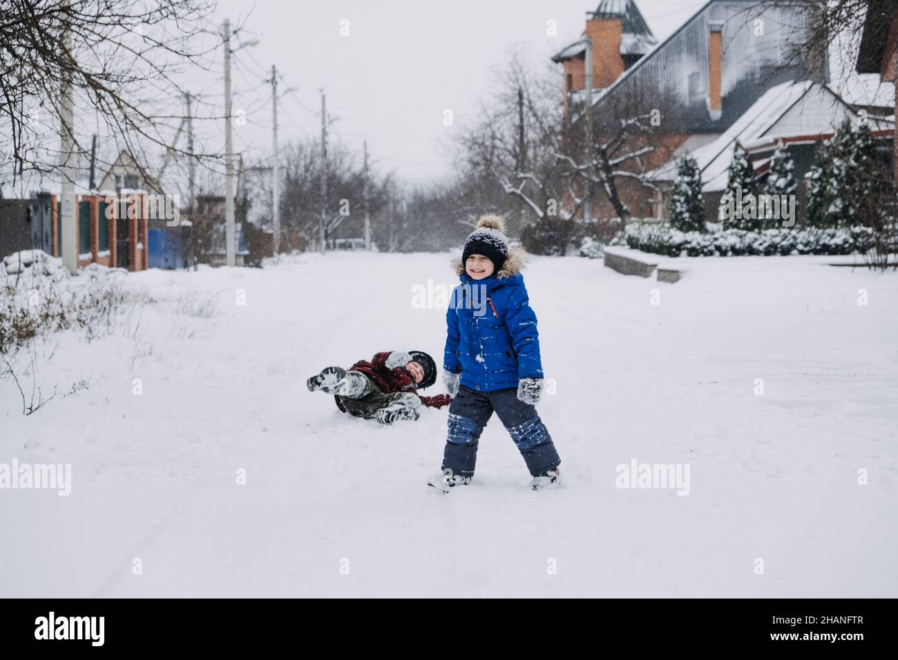 Outdoor winter activities for kids. Kids playing in the suburbs, winter ...