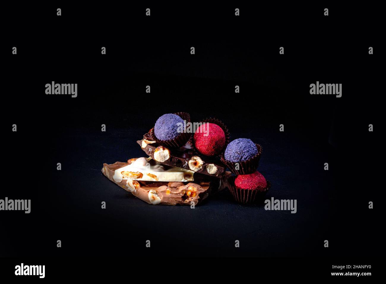 Chocolate bar, crushed pieces of dark chocolate and nuts. Praline ...