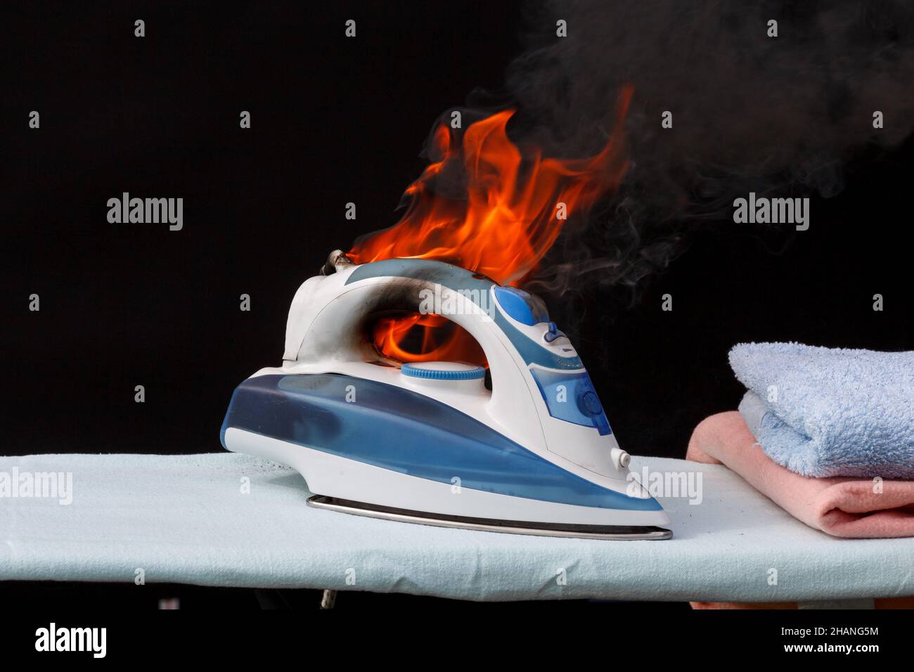 Iron in flames of fire, faulty wiring, cause of fire Stock Photo - Alamy