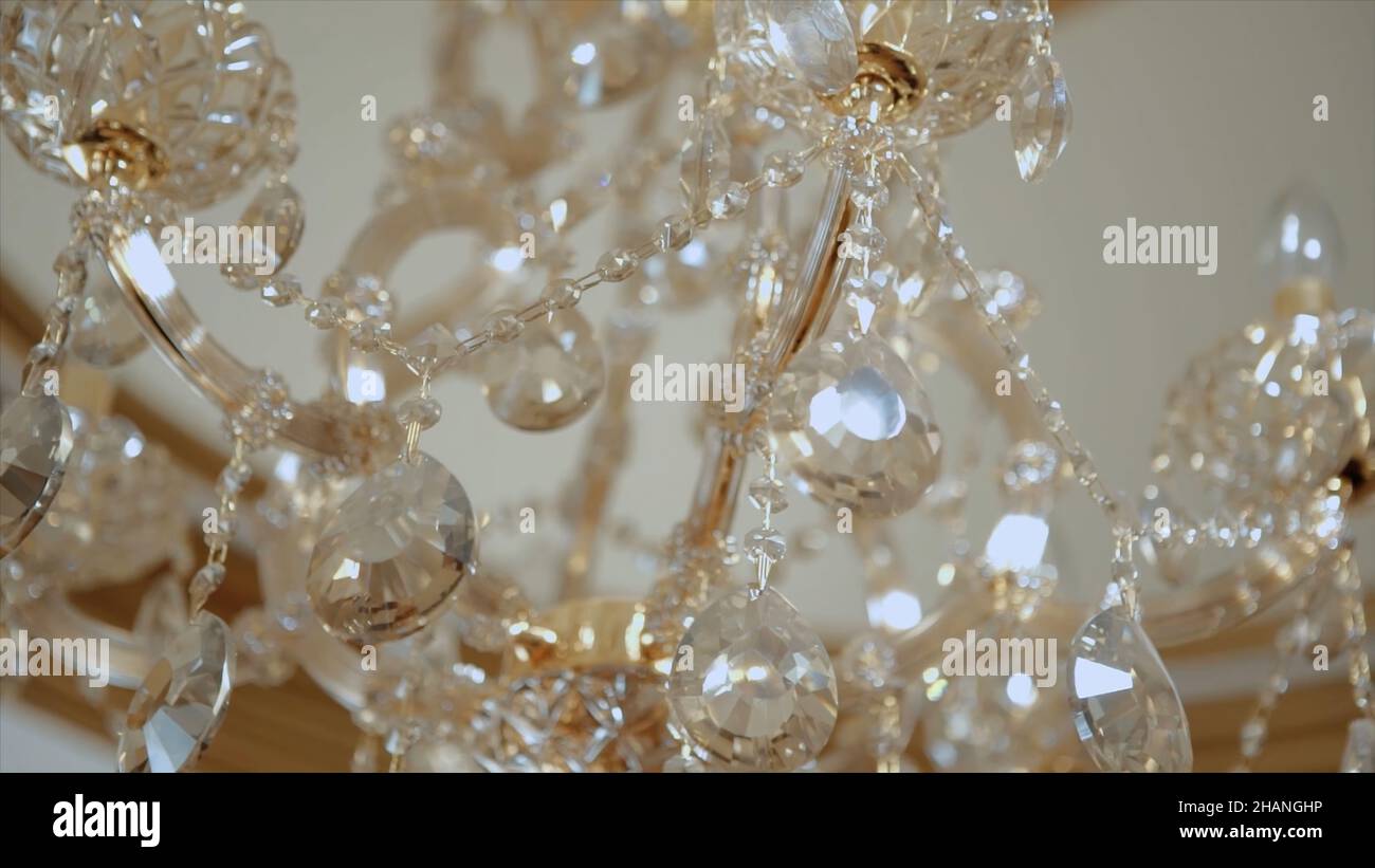 Elegant luxury chandelier with crystal on the ceiling inside a building ...