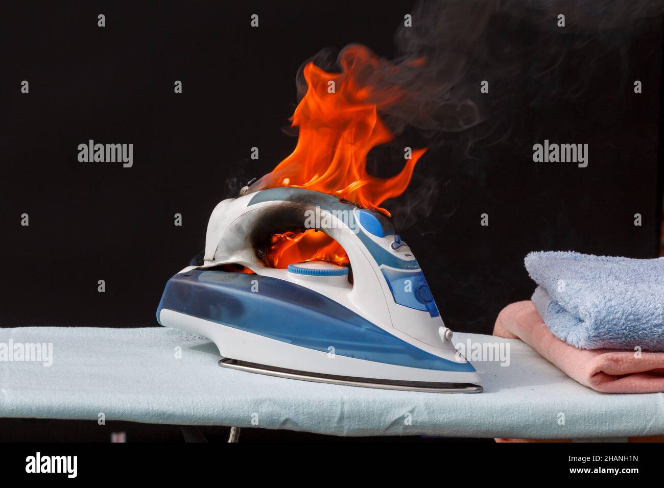 Iron in flames of fire, faulty wiring, cause of fire Stock Photo - Alamy