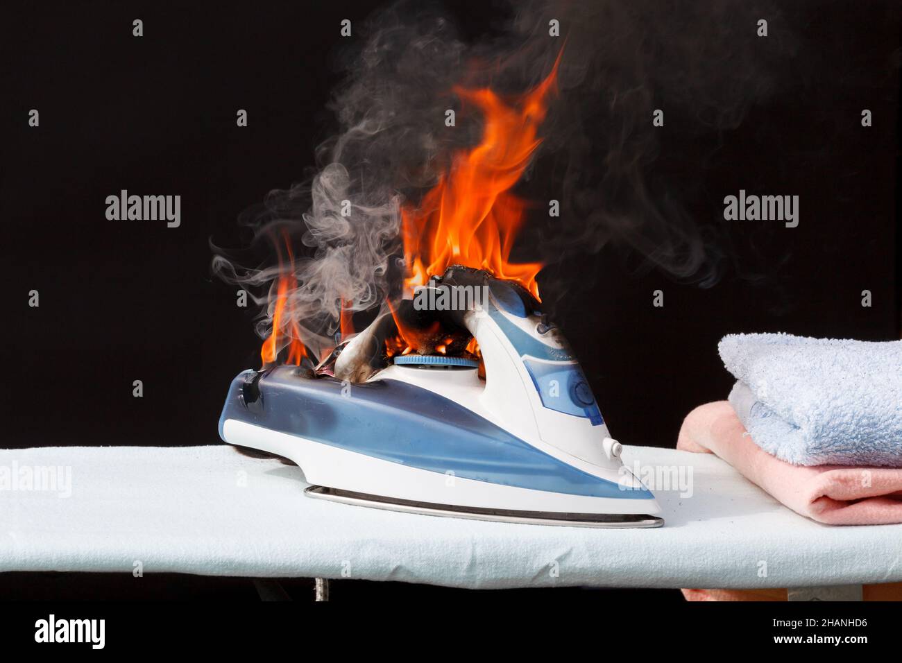 Iron in flames of fire, faulty wiring, cause of fire Stock Photo - Alamy