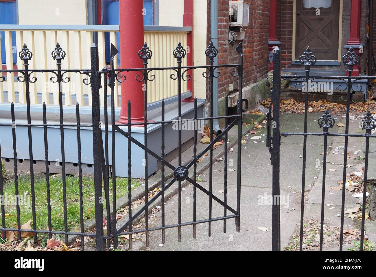 The black metal gate was left open, somone should close it Stock Photo ...