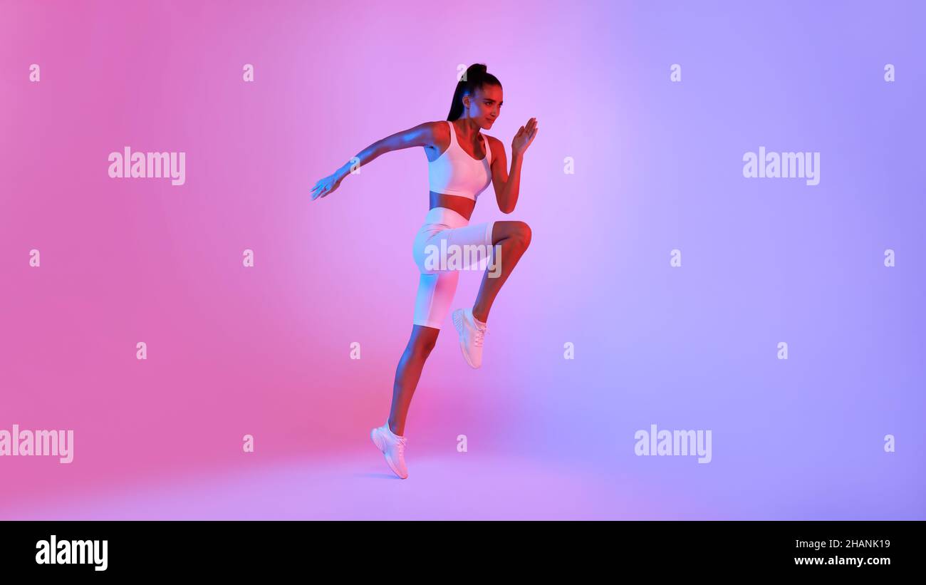 Sporty Woman Jumping Exercising Posing Over Neon Background, Panorama ...