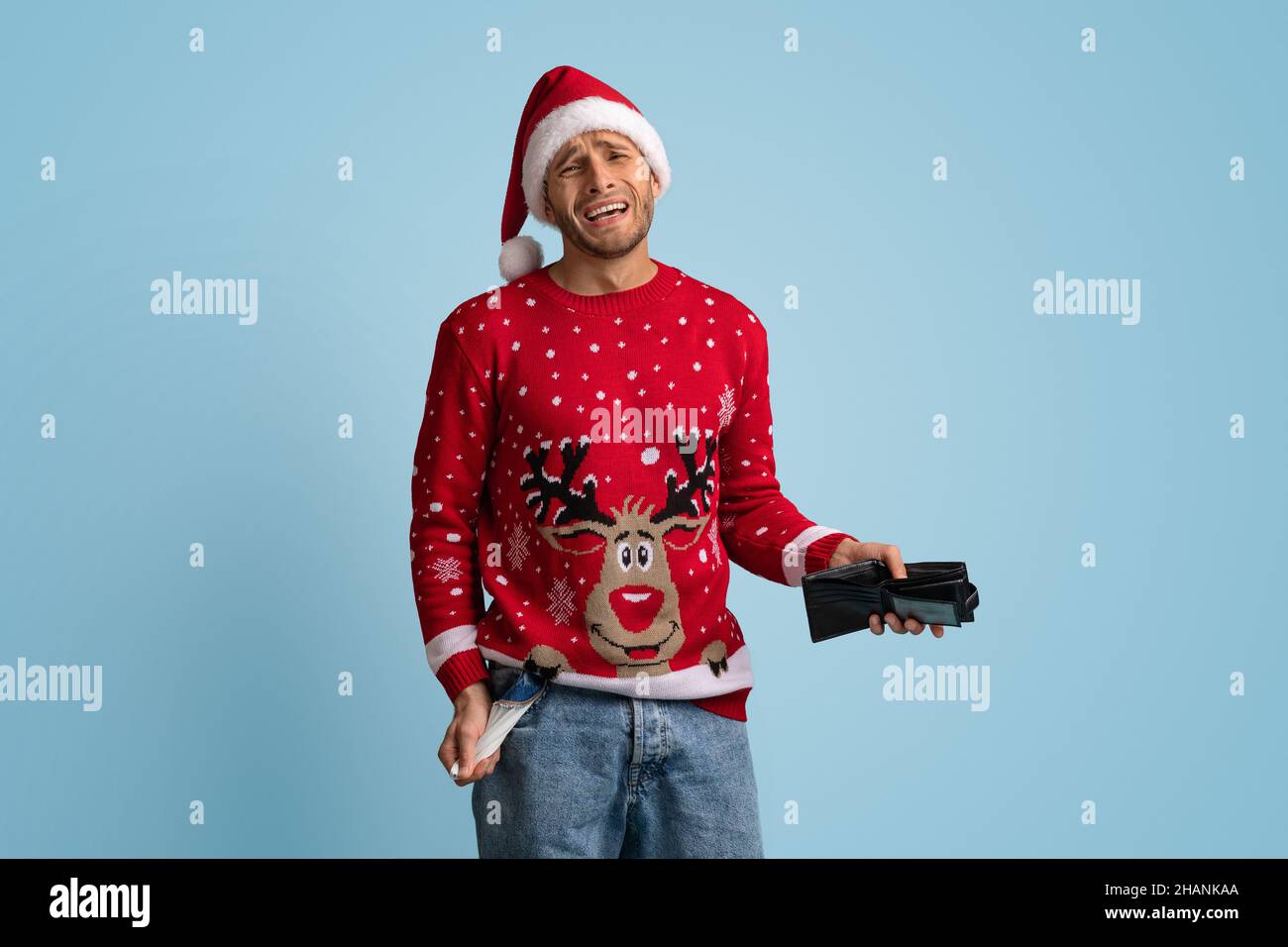 Crying Young Man In Santa Hat Showing Empty Wallet And Pocket Stock ...