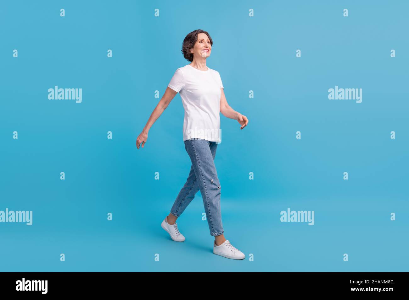 Full length body size view of attractive cheerful woman walking ...