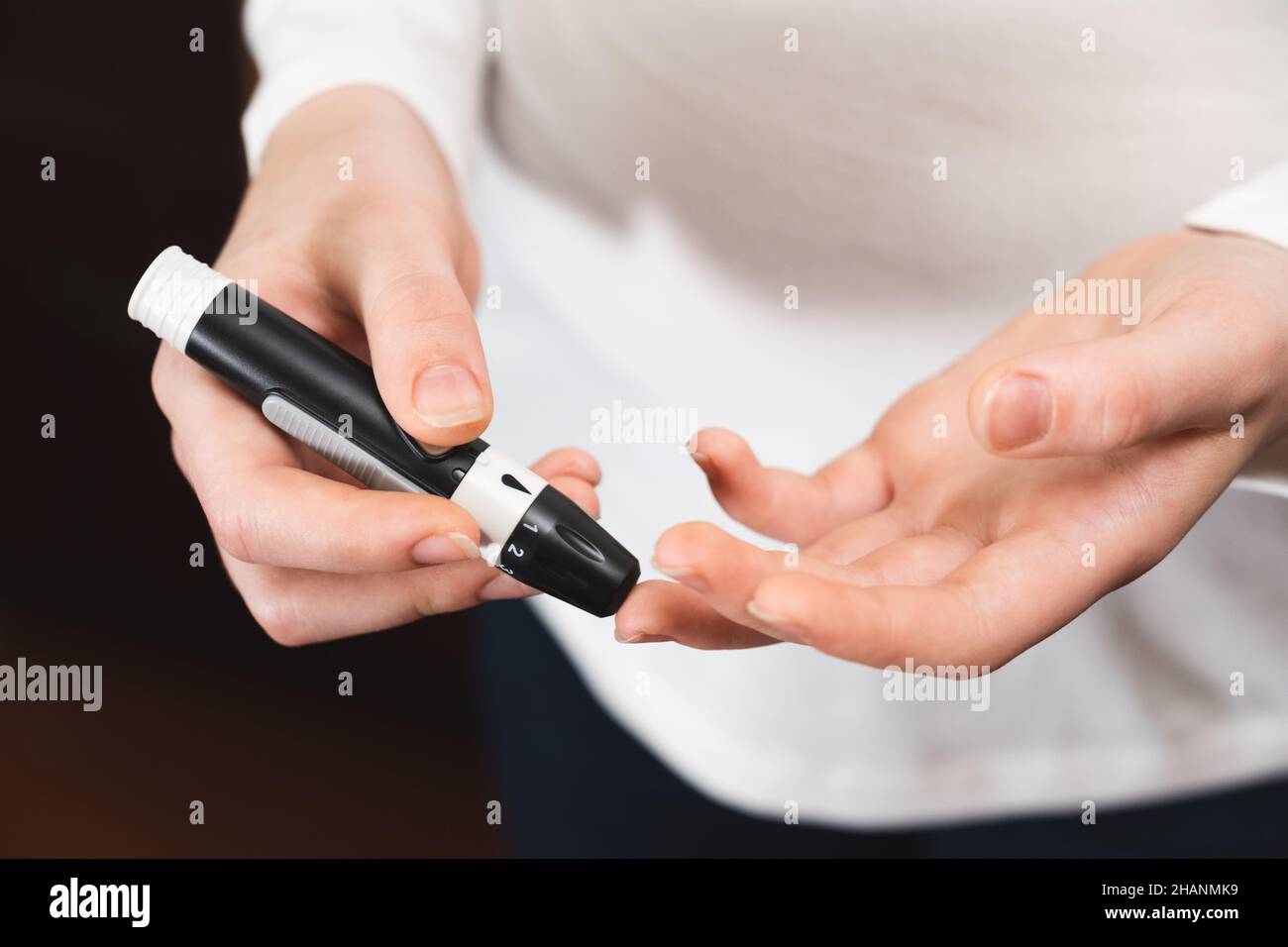 Child Hands Using Lancet on Finger to Check Blood Sugar Level by ...