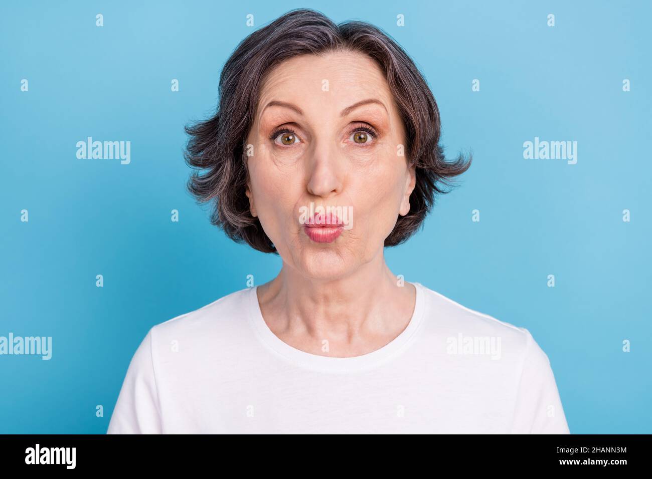 Portrait Of Attractive Grey Haired Woman Sending You Air Kiss Amour
