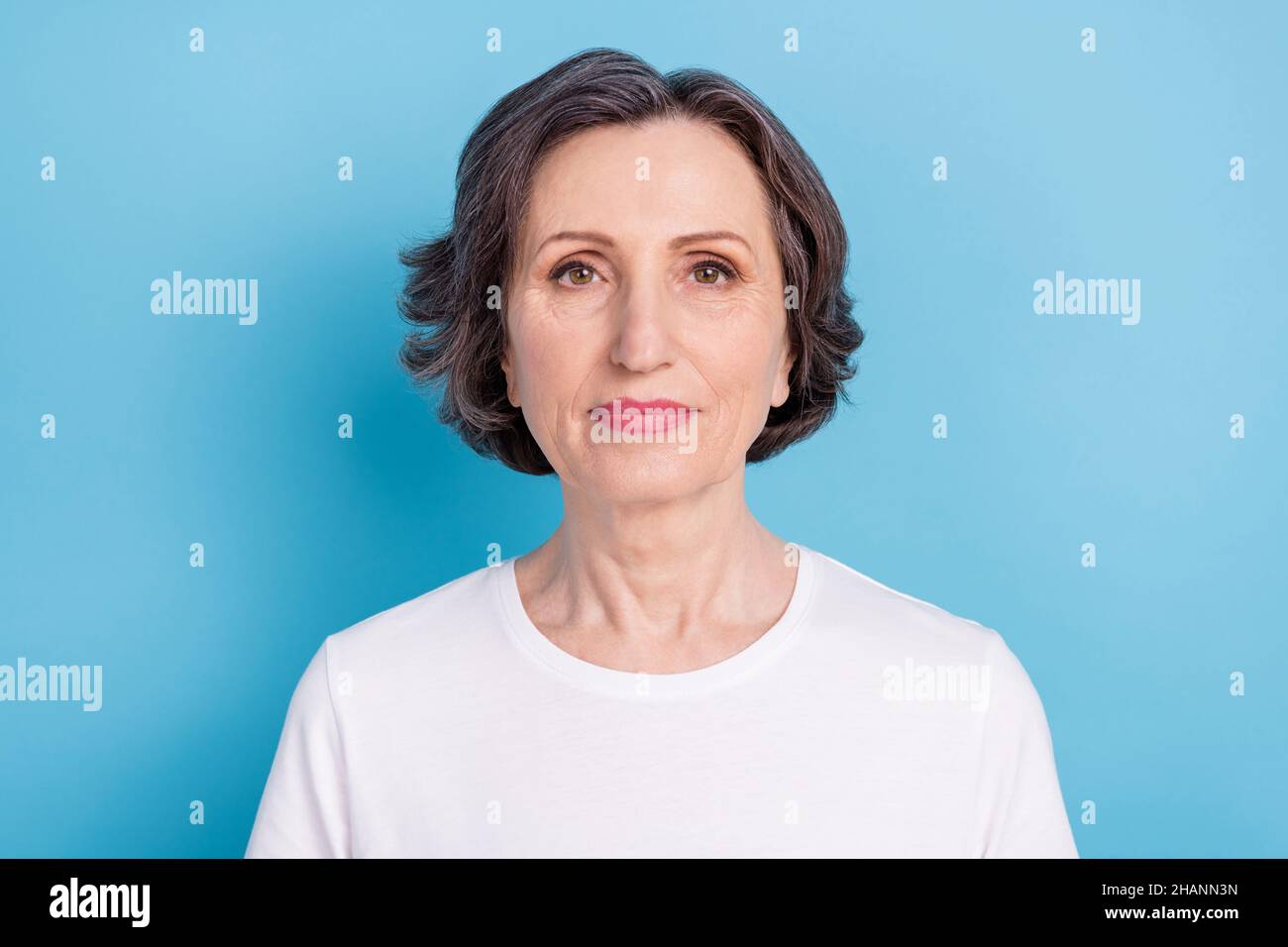 Portrait Of Attractive Content Grey Haired Woman Wearing White T Shirt
