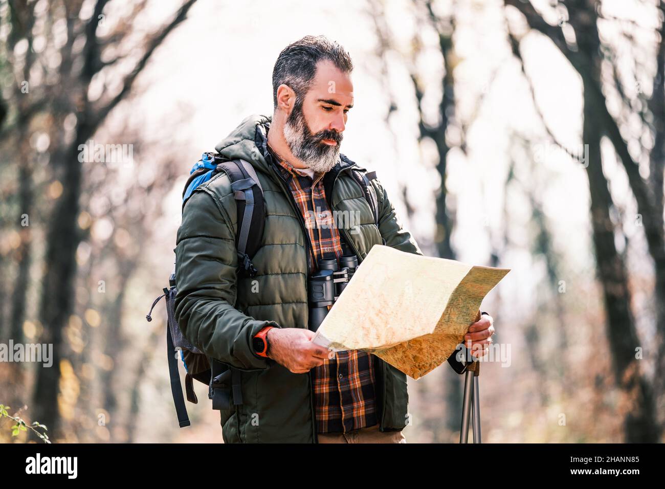 Image of man hiking and looking at map Stock Photo - Alamy