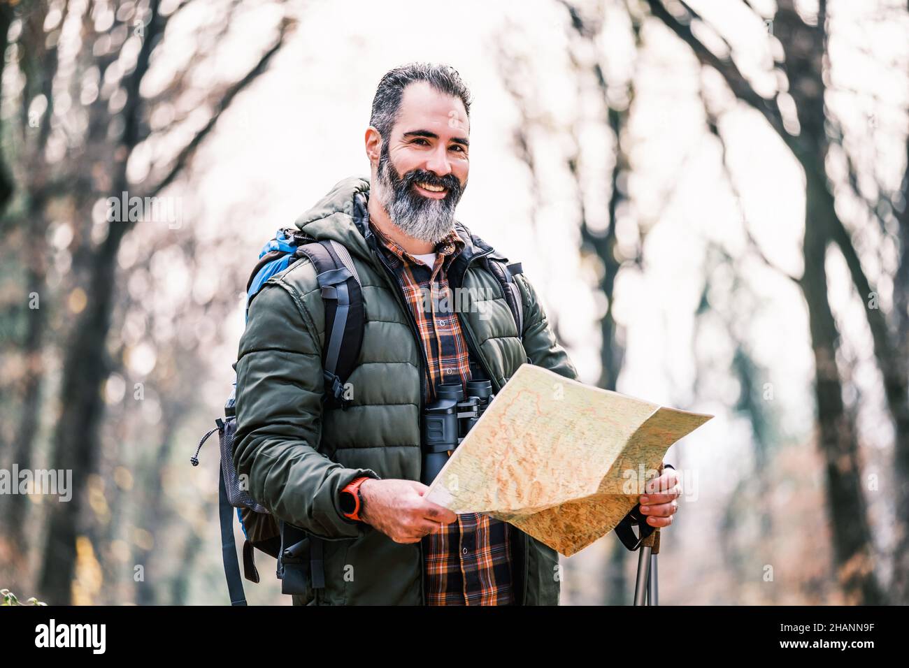 Image of man hiking and looking at map Stock Photo - Alamy