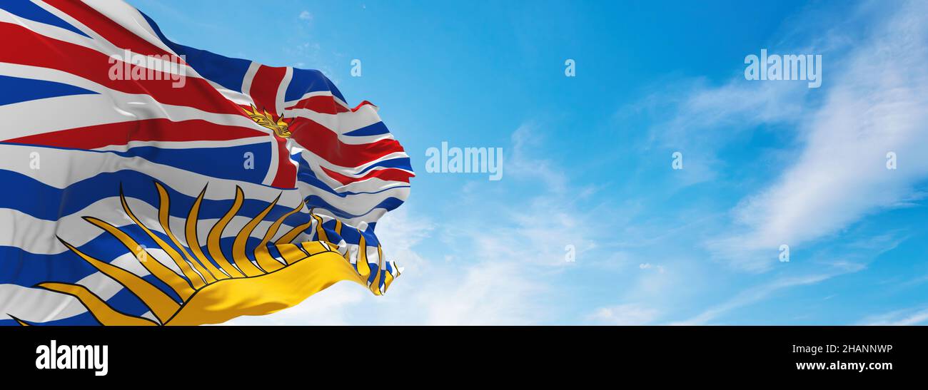 flag of British Columbia , Canada at cloudy sky background on sunset ...