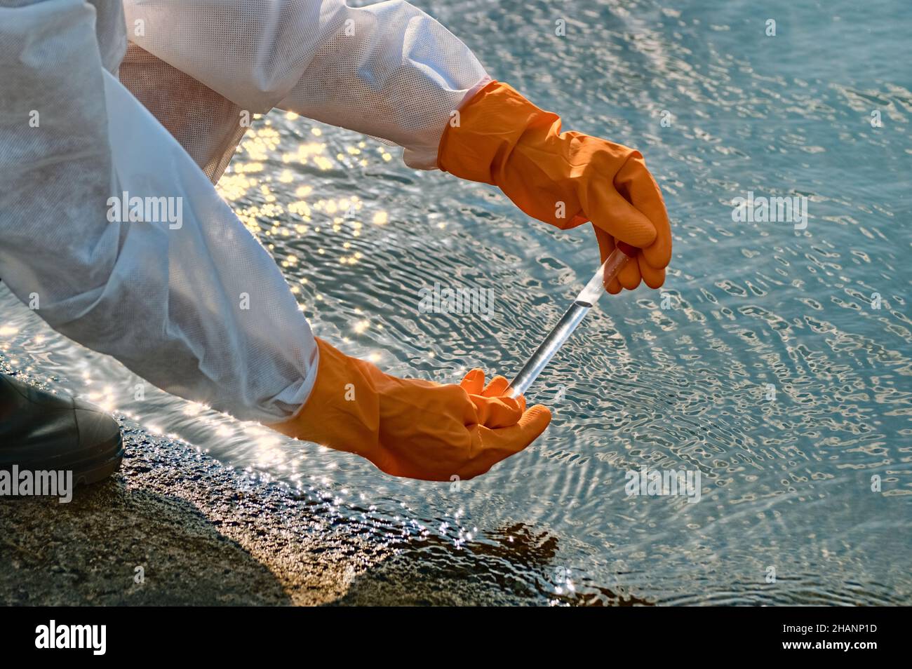 checking the water by a specialist in a protective suit and mask Stock ...