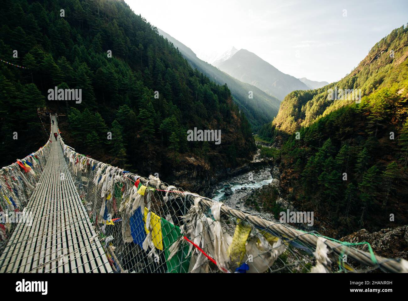 Suspension bridge with buddhist prayer flags on the Annapurna circuit ...